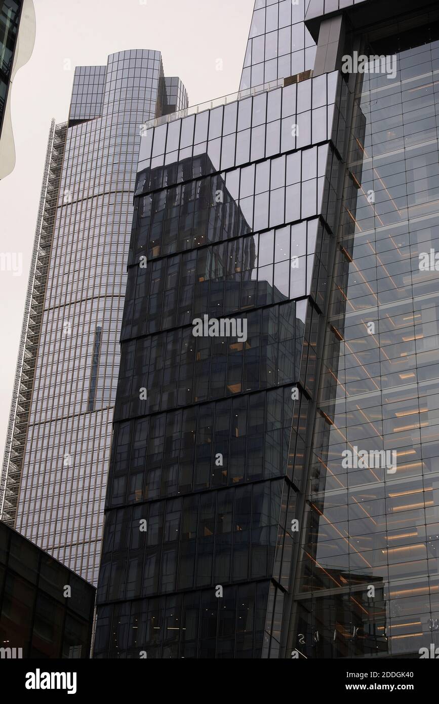 Tall skyscrapers reflecting in glass mirrored facade of high rise ...