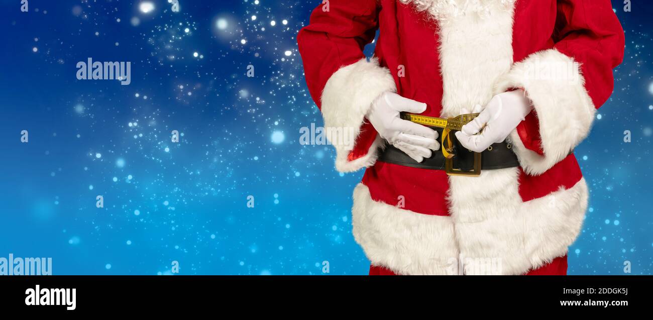 Santa measures his stomach circumference with a tape measure against an ...