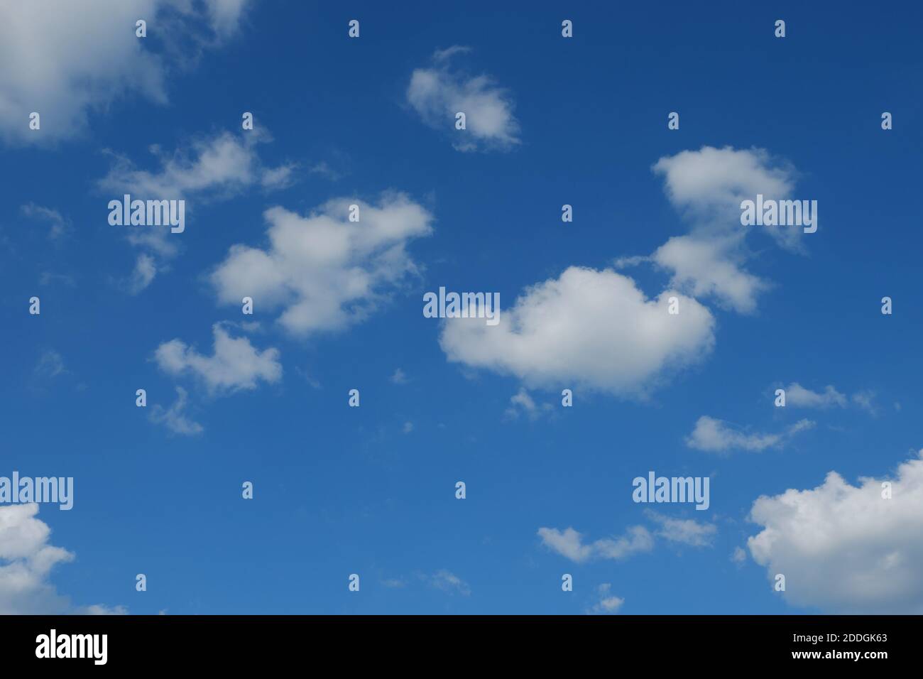 Little cumulus clouds on a blue sky. Background Stock Photo - Alamy