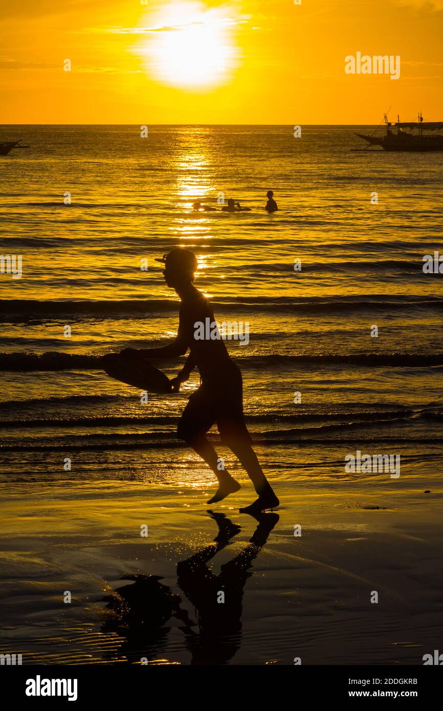A skimboarder at the beach in Boracay Island, Philippines Stock Photo ...