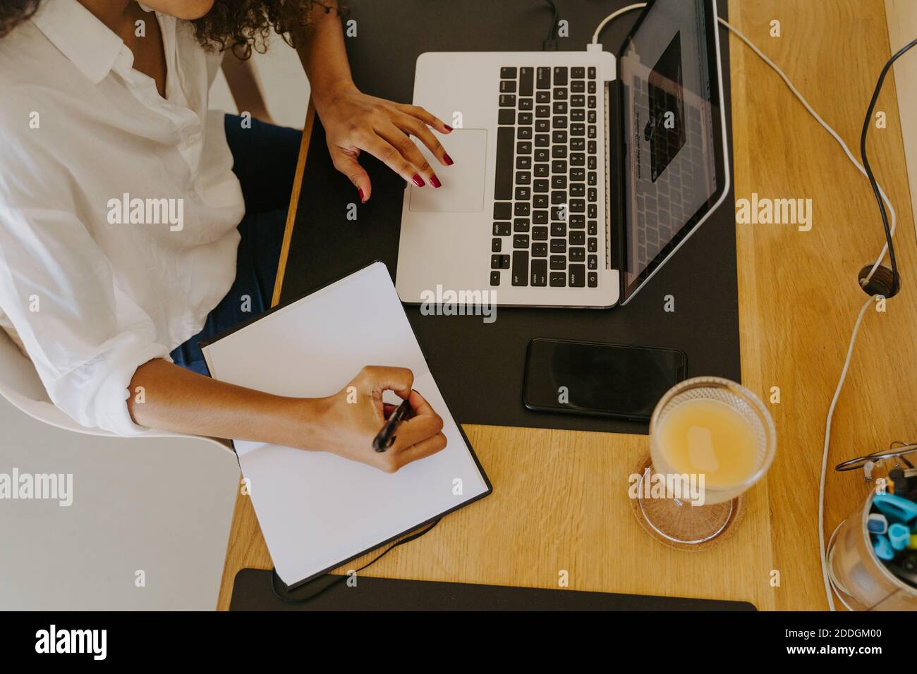 From above cropped unrecognizable female remote employee in casual ...