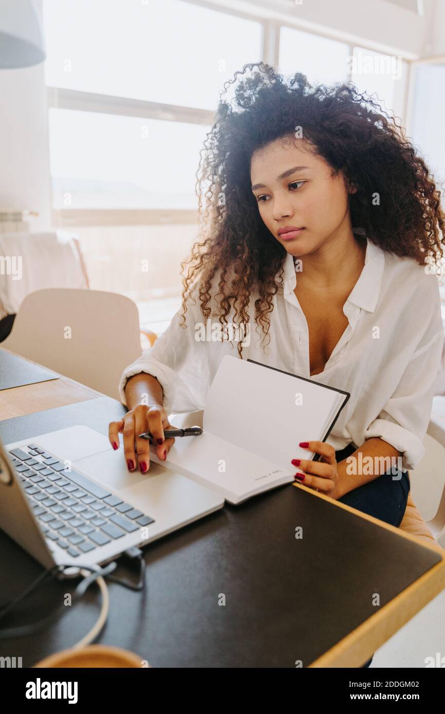 Modern young African American female remote employee in casual outfit ...
