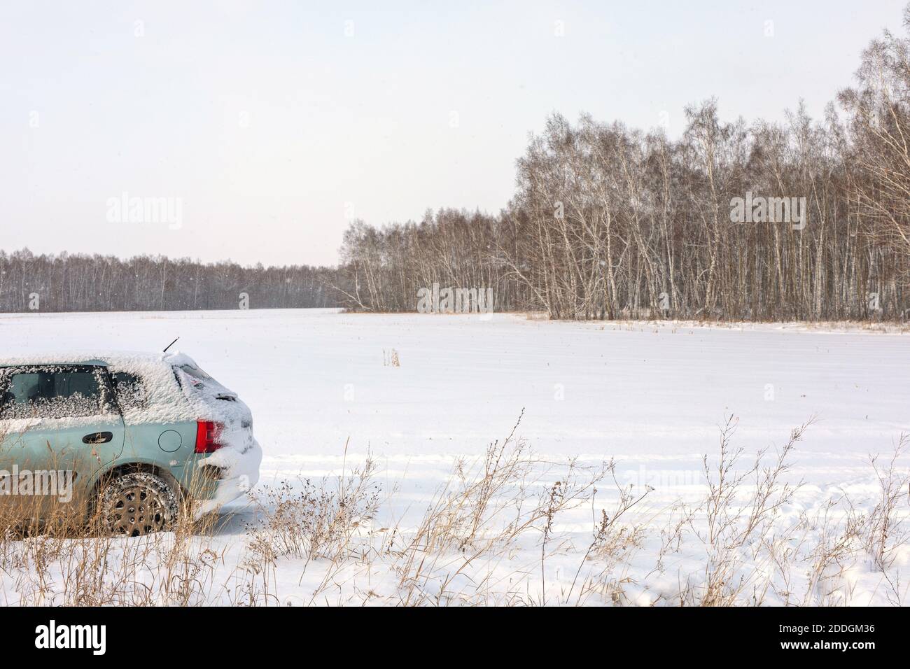 Danger of getting stuck in snow. Unexpected snowfall covered car with ...