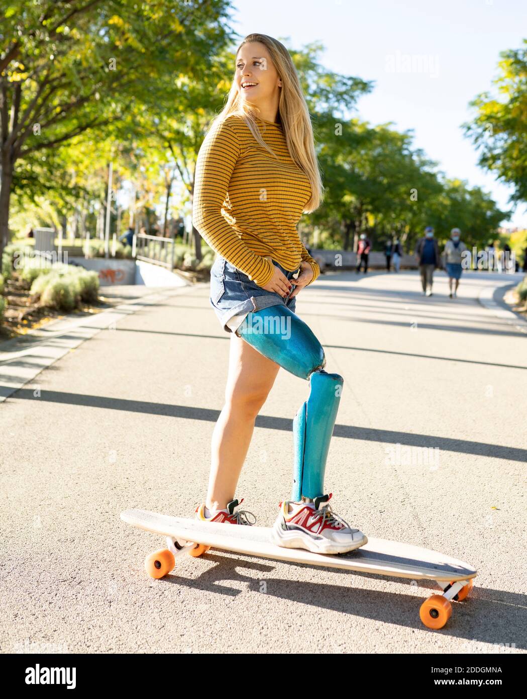 Side view of positive female with leg artificial limb of leg riding ...