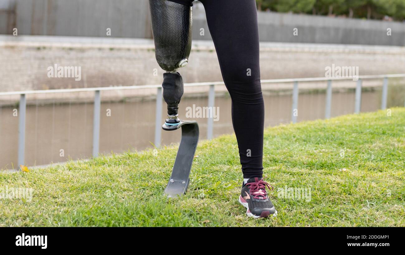 Front view of crop anonymous female runner with leg prosthesis ...