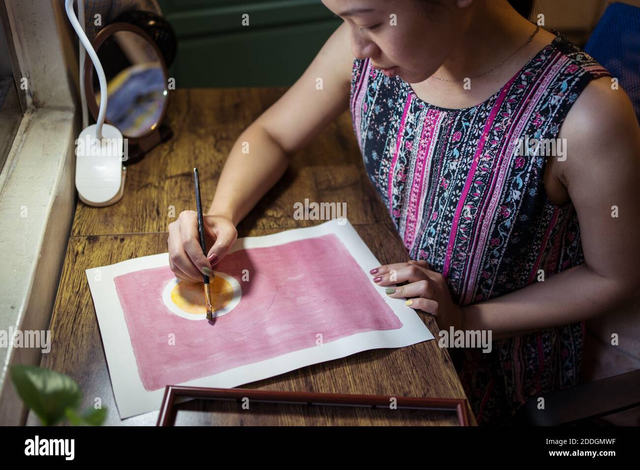 From above view of crop unrecognizable female artist creating picture ...