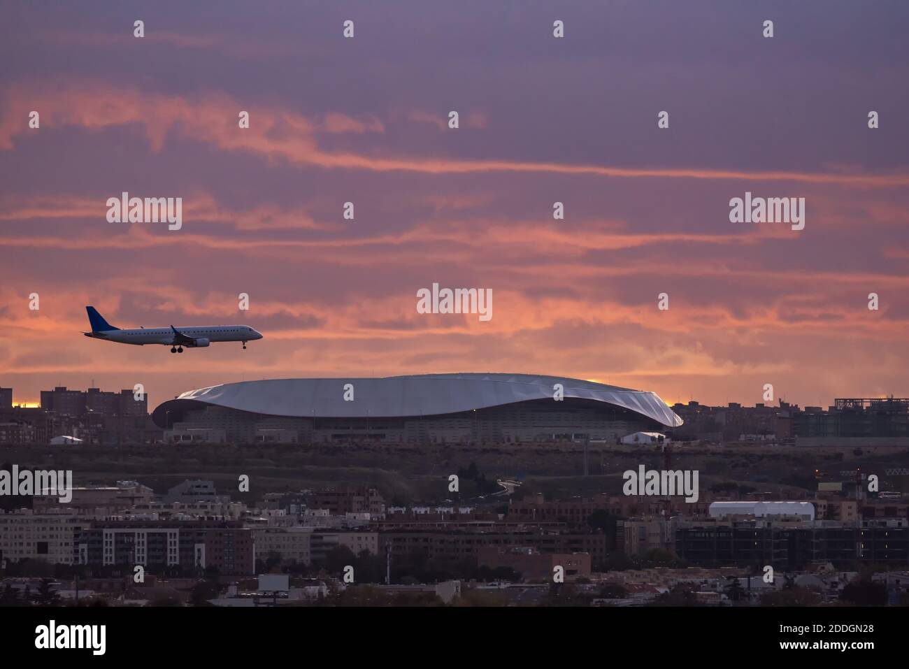Peaceful view of contemporary aircraft flying over Madrid on background ...