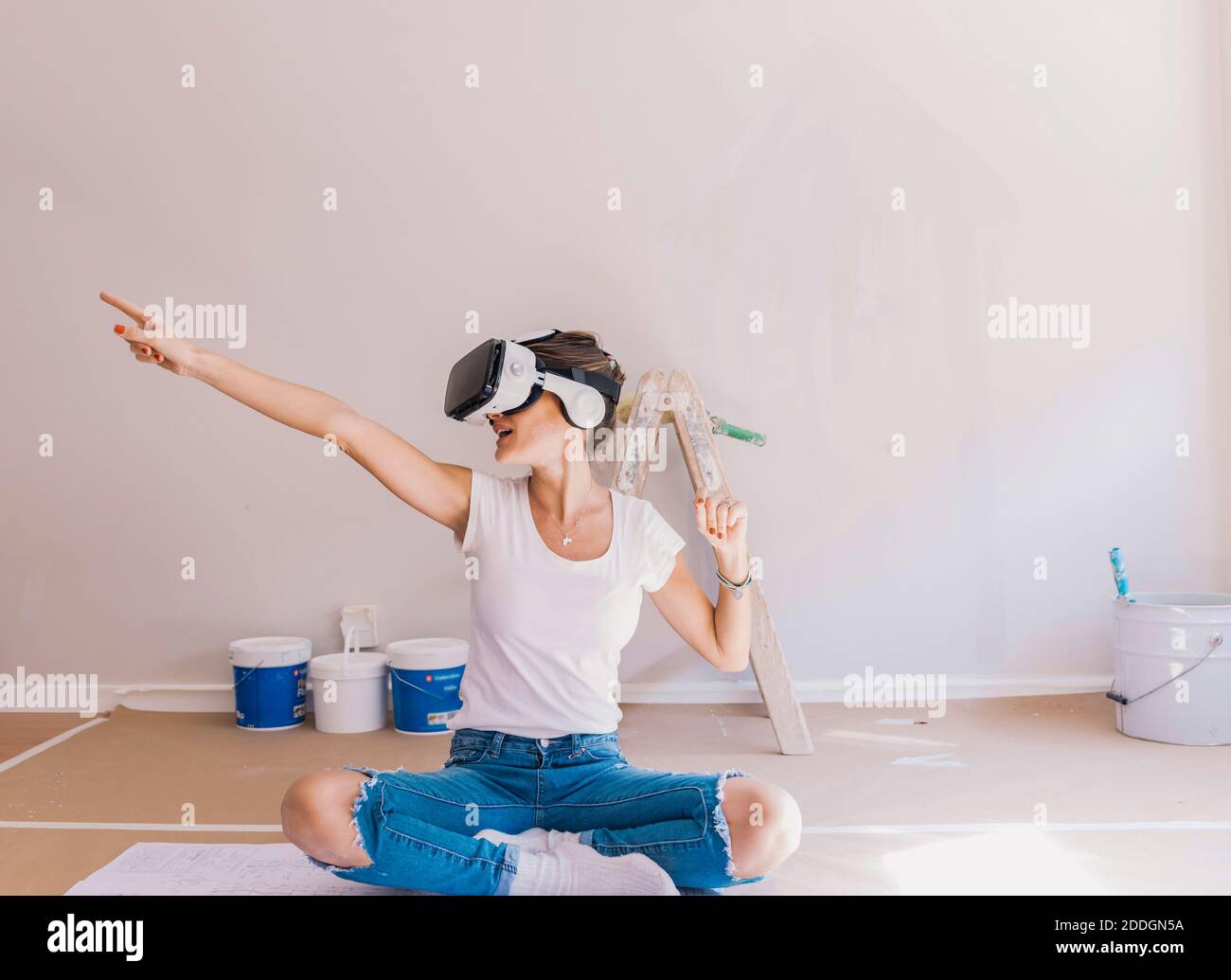 Young Woman in VR headset gesticulating while visualizing apartment ...