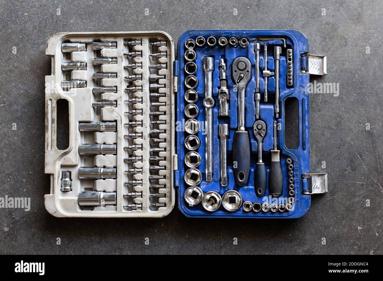 Top view of kit of metal wrenches and bits placed inside plastic box on ...
