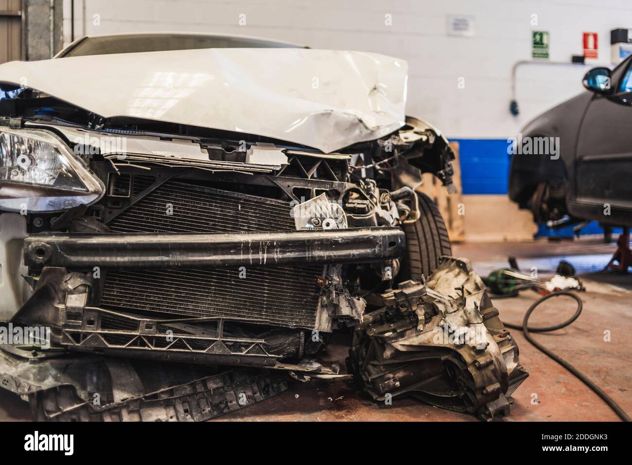 Modern vehicle with wrecked front parked inside spacious professional ...