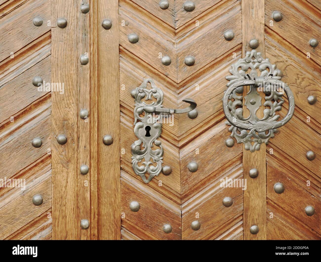 Old wooden door with rivets. Metal handle and door lock Stock Photo - Alamy
