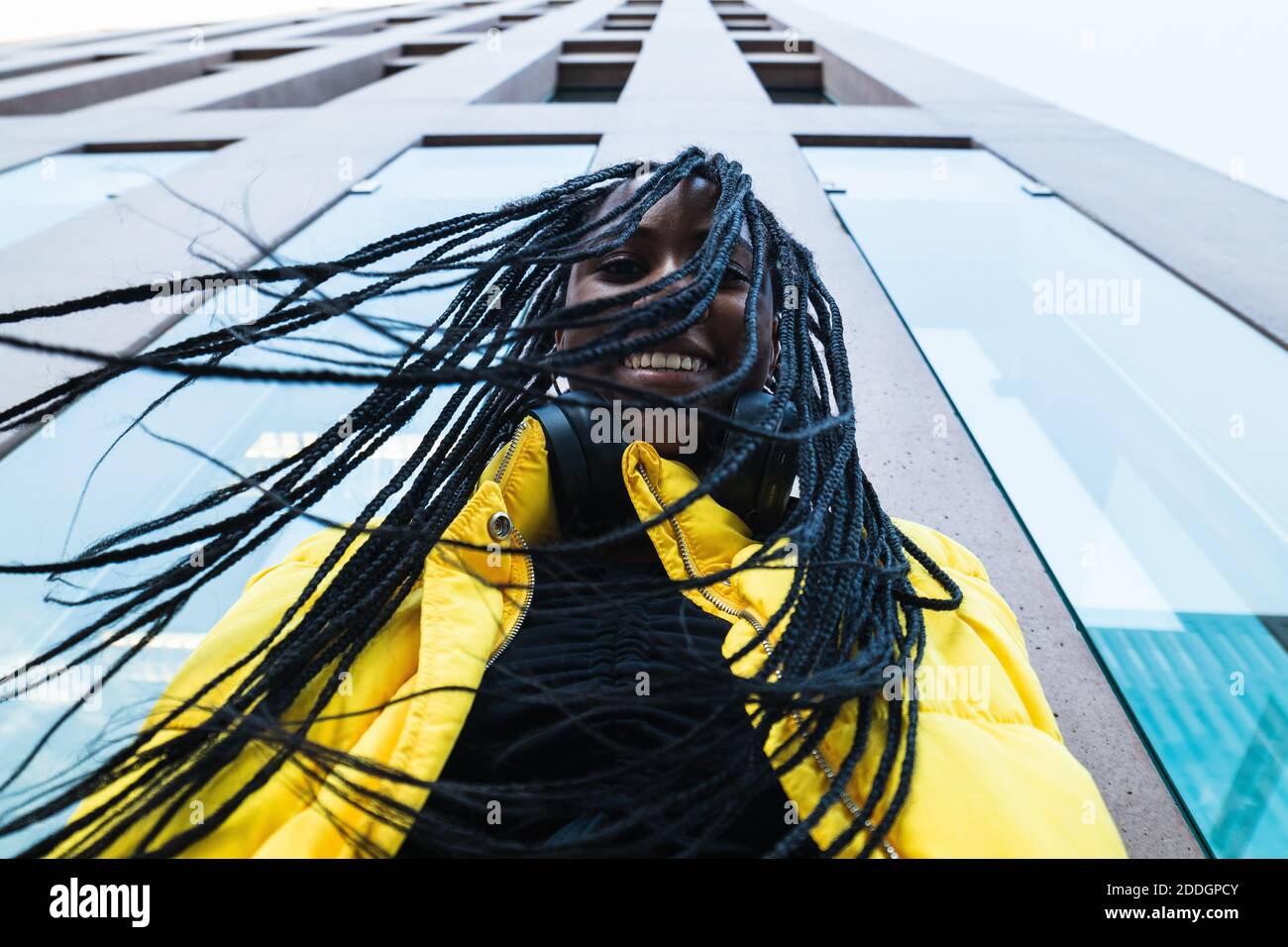From below young African American female with braids standing outside ...