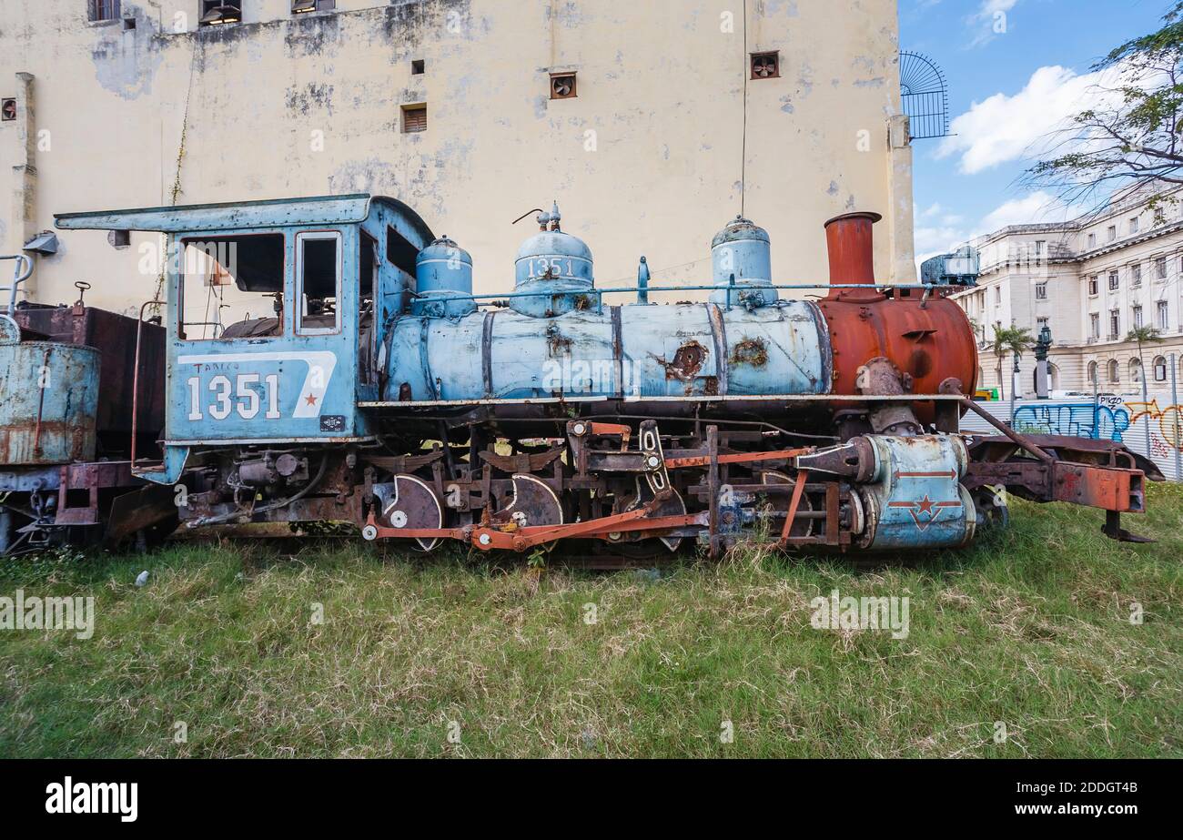 A rusting, derelict locomotive train engine abandoned in a scrapyard in ...
