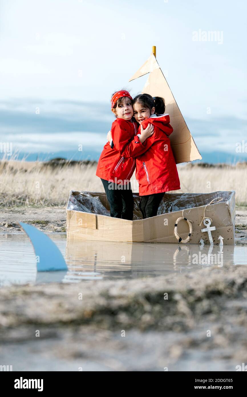 Frightened playful kids scared of carton shark hugging in handmade ...