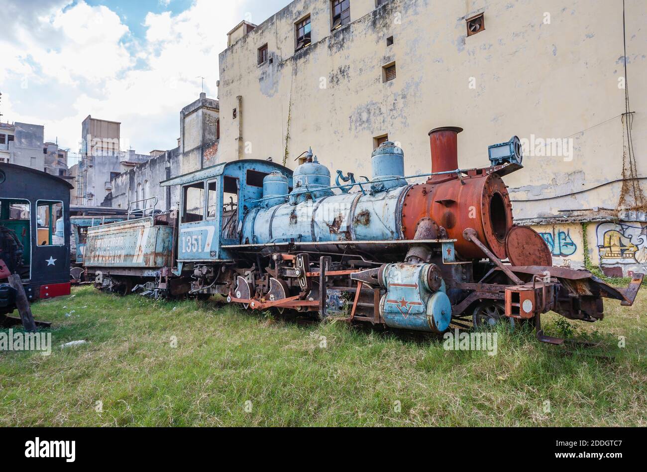 A rusting, derelict locomotive train engine abandoned in a scrapyard in ...