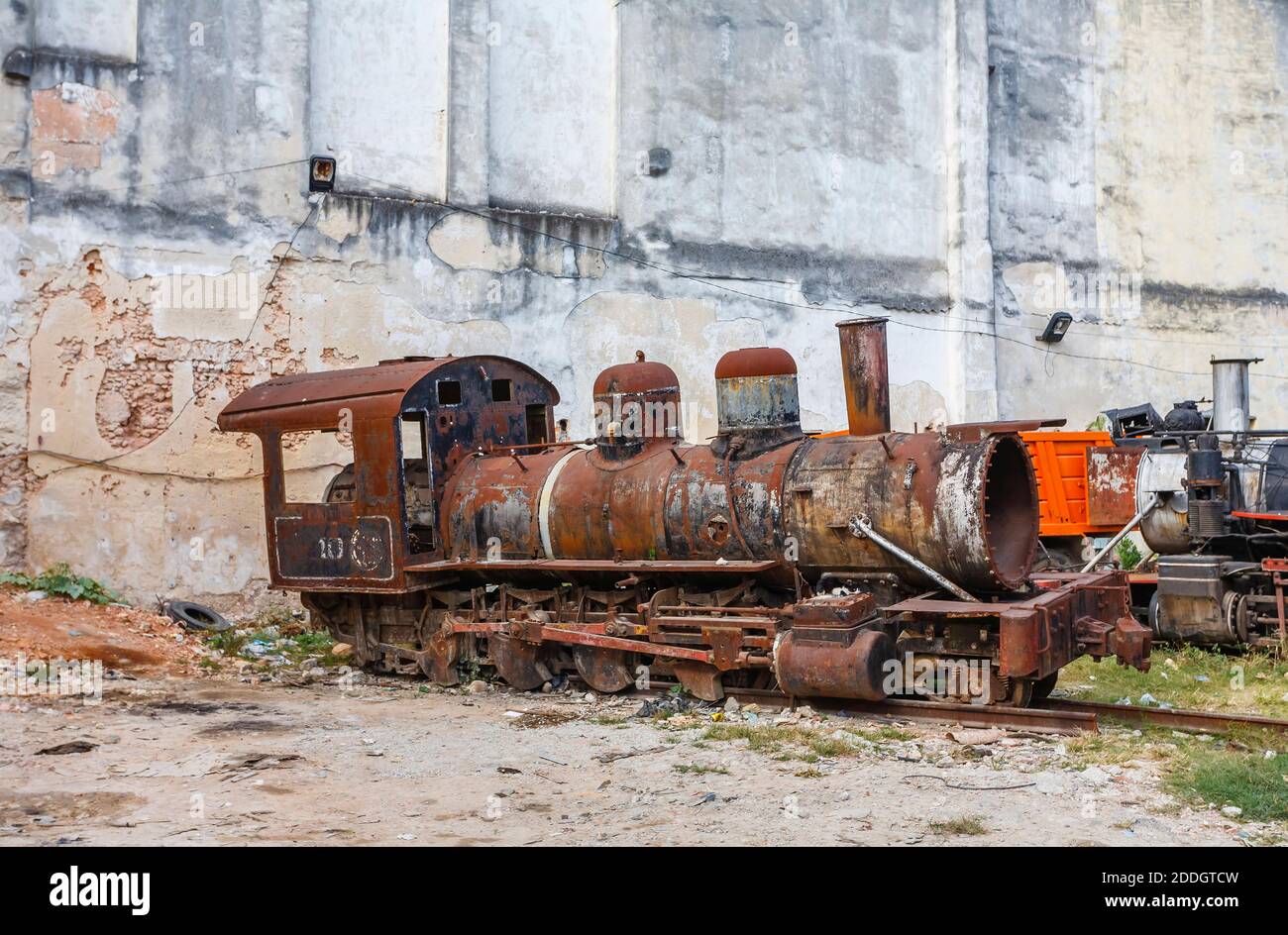 A rusting, derelict locomotive train engine abandoned in a scrapyard in ...