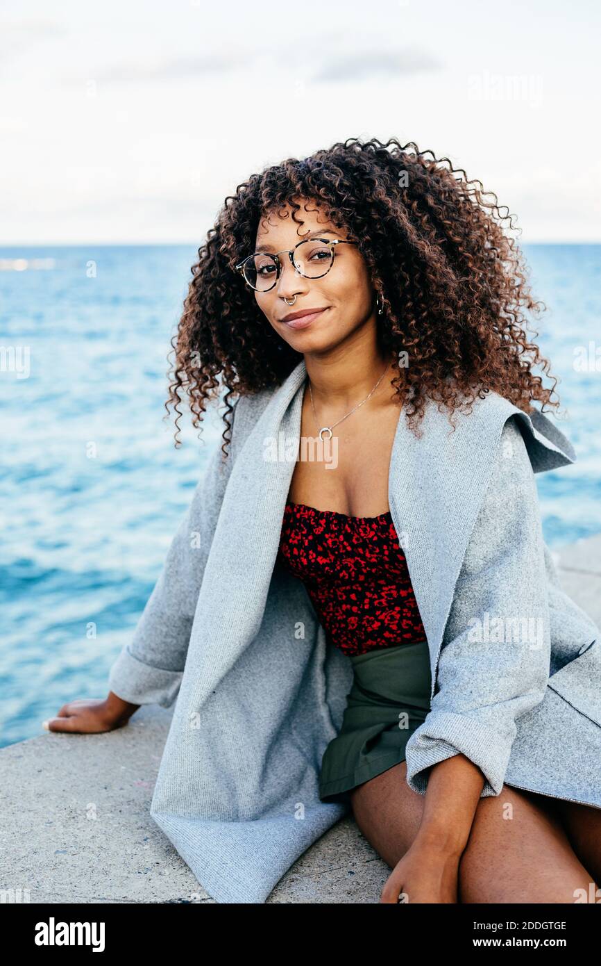 Ethnic male musician holding chord on strings of guitar while playing ...