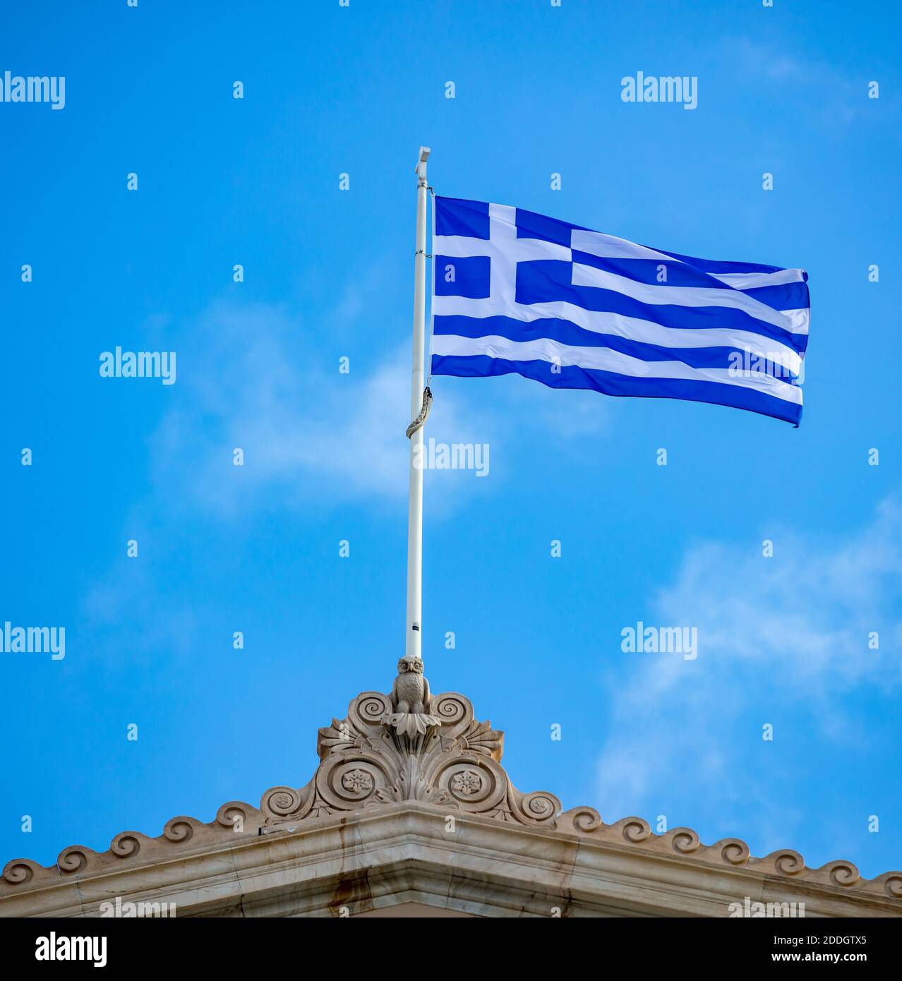 Greek flag waving on pole against clear blue sky background, copy space ...