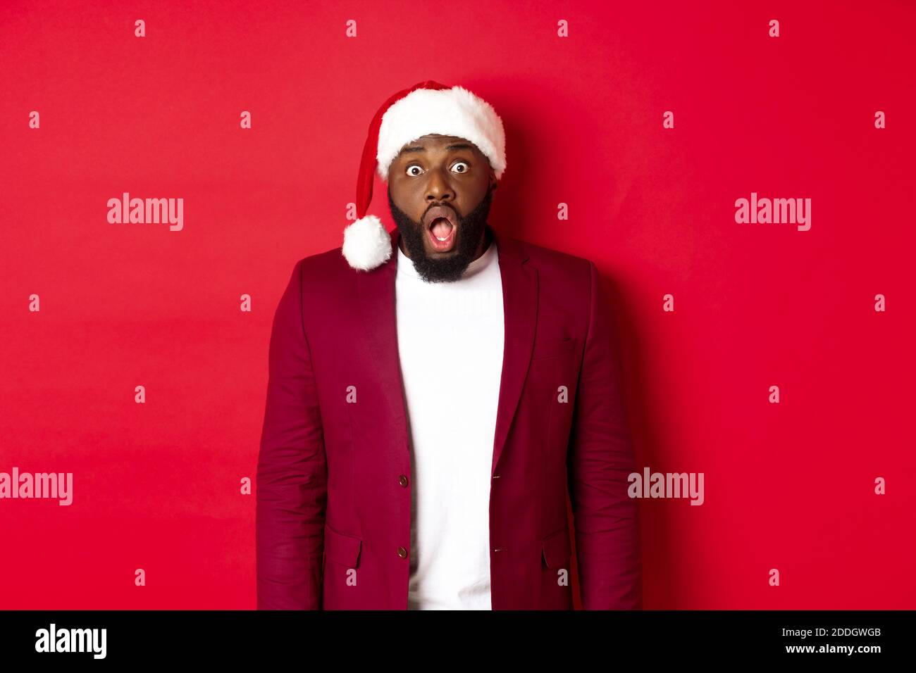 Christmas, party and holidays concept. Shocked Black man in santa hat ...