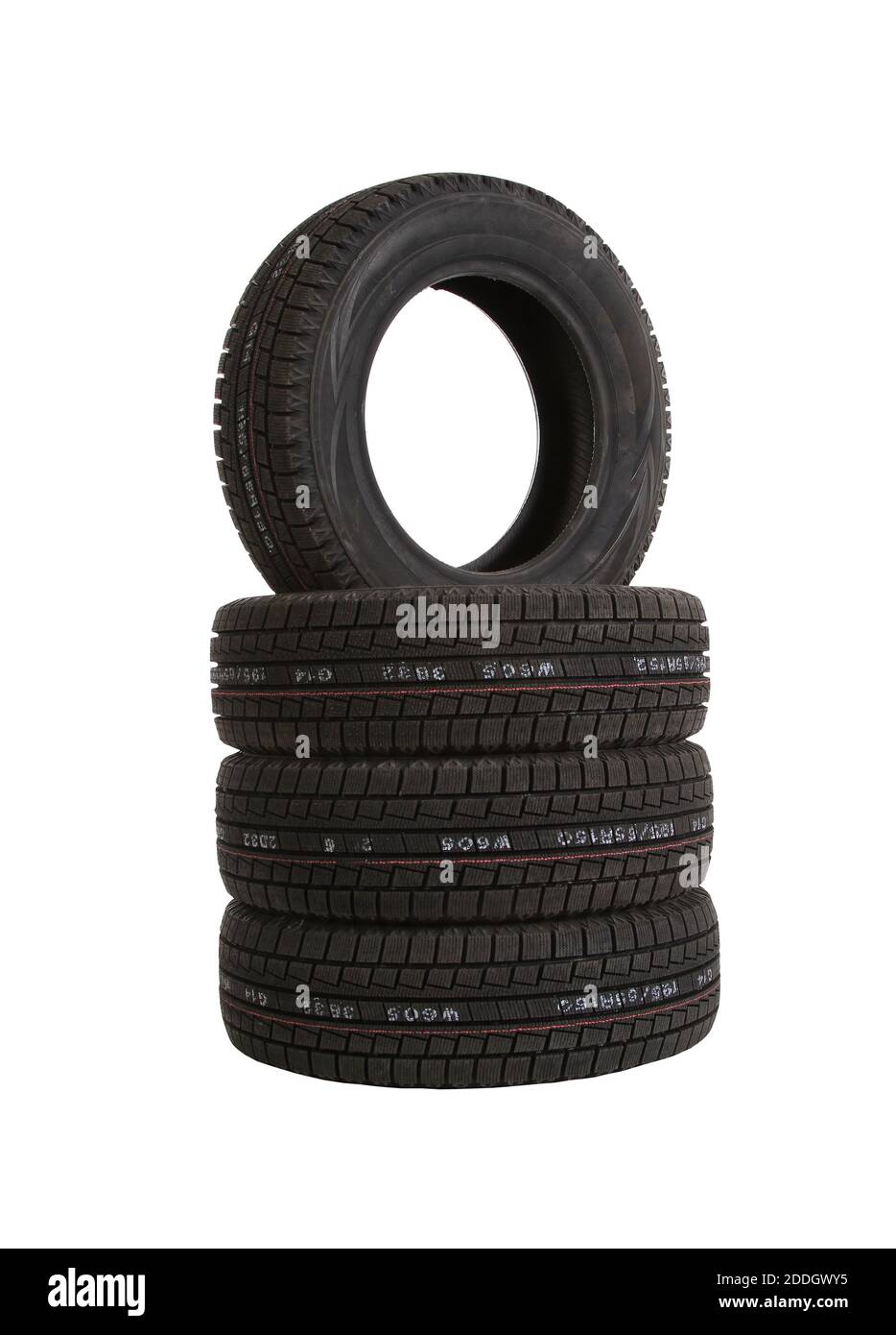 A vertical shot of a stack of car tires isolated on a white background ...