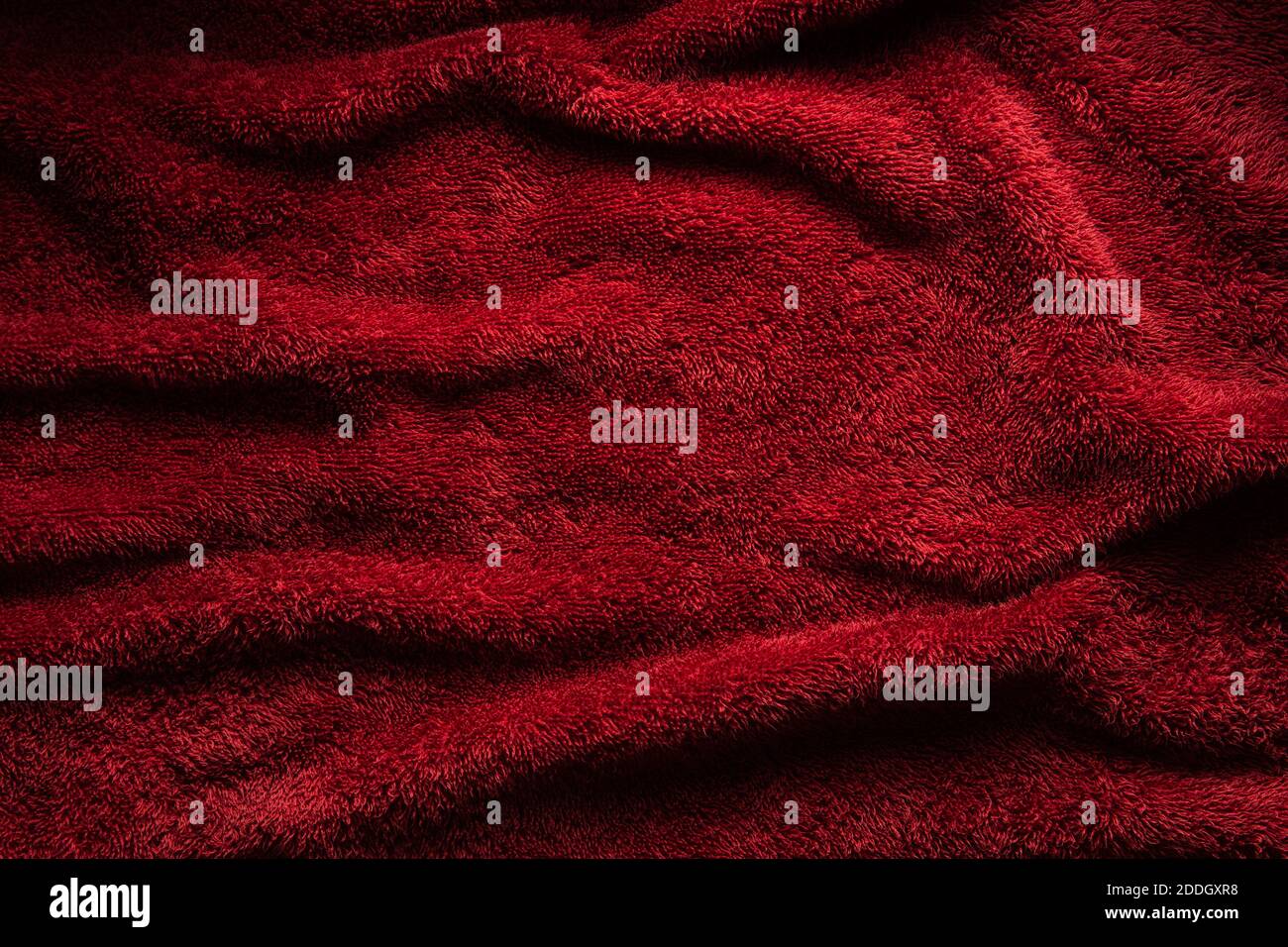 A soft red terry towel. Burgundy texture background. Underlay and free ...