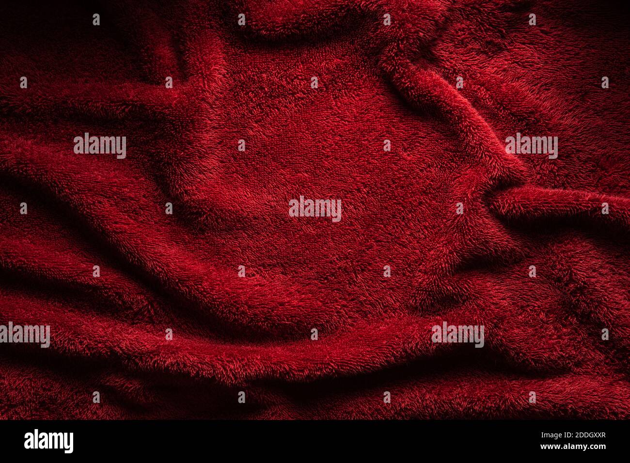 A soft red terry towel. Burgundy texture background. Underlay and free ...