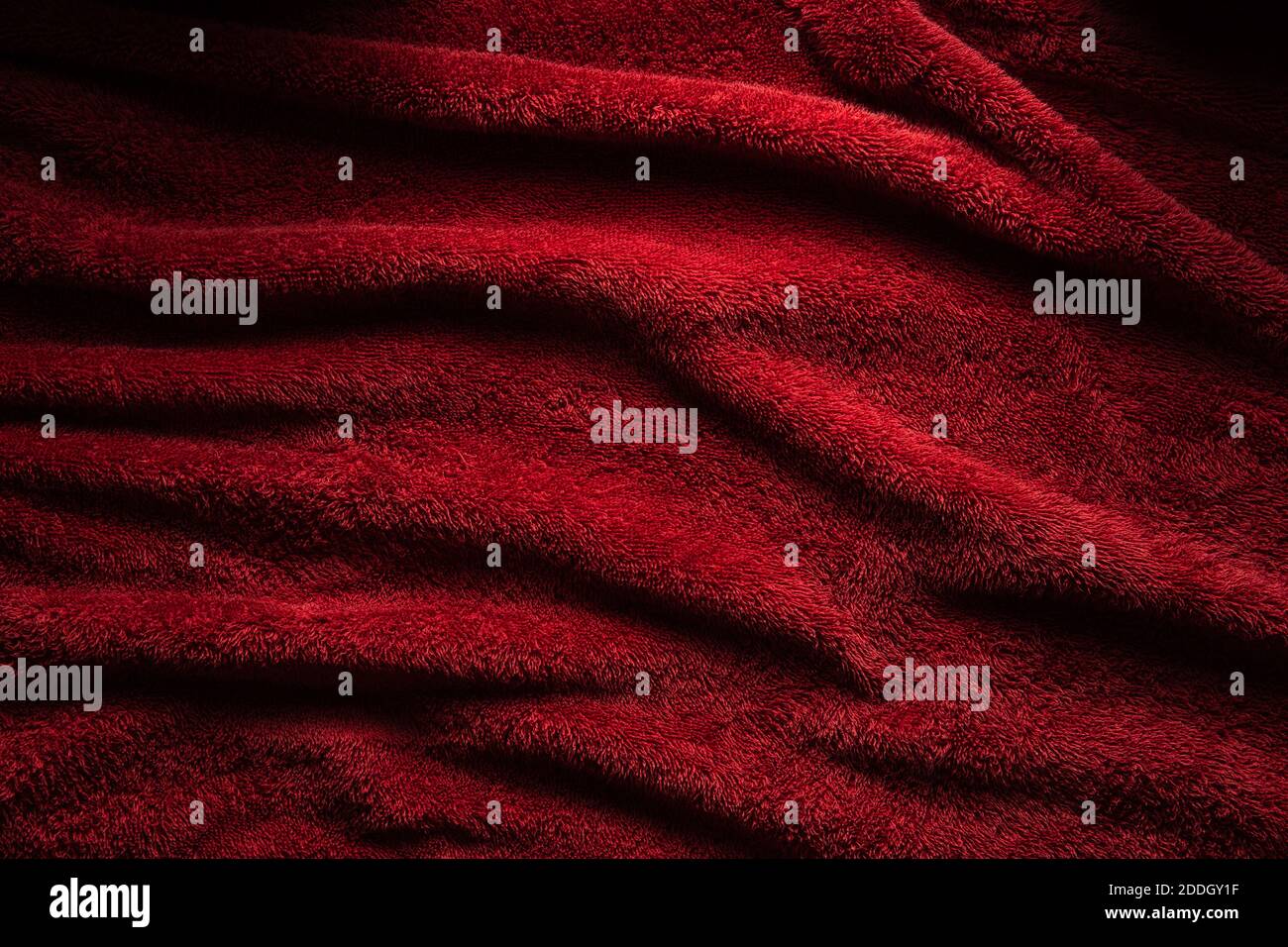 A soft red terry towel. Burgundy texture background. Underlay and free ...