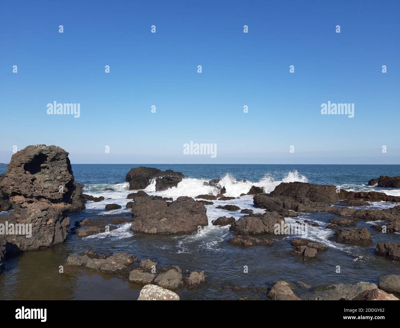 Waves hitting the coast side in Udo island. Udo is a small island ...