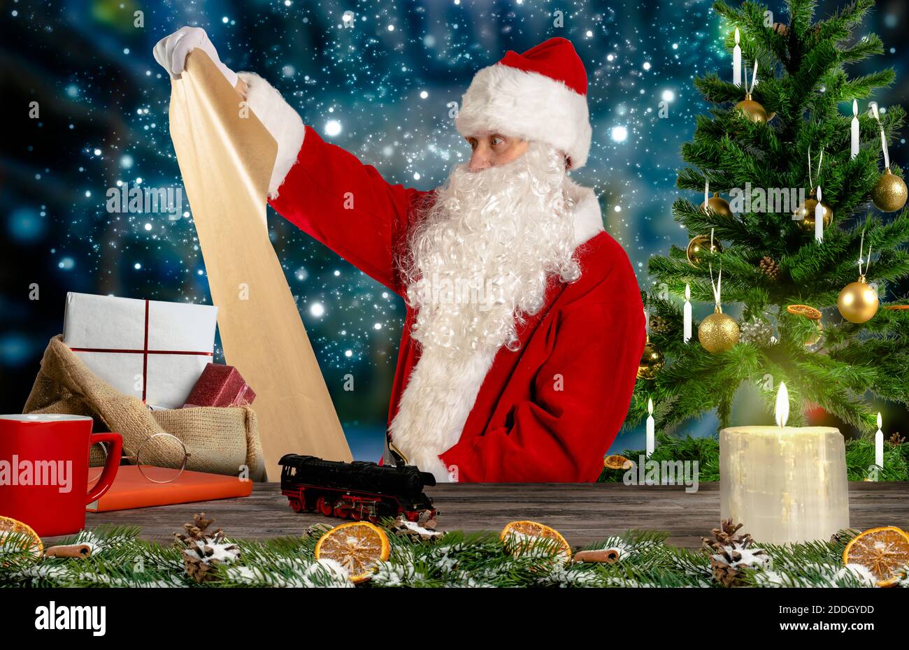 santa claus checks the wish list for the gifts in his workshop Stock ...