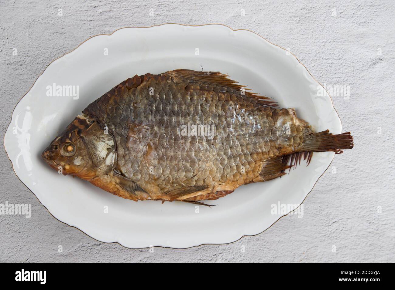Whole fish cooked white background hi-res stock photography and images ...