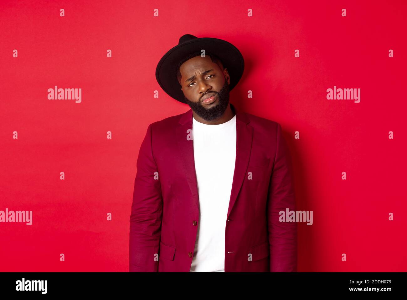 Sad and unamused Black man looking with pity at camera, frowning ...