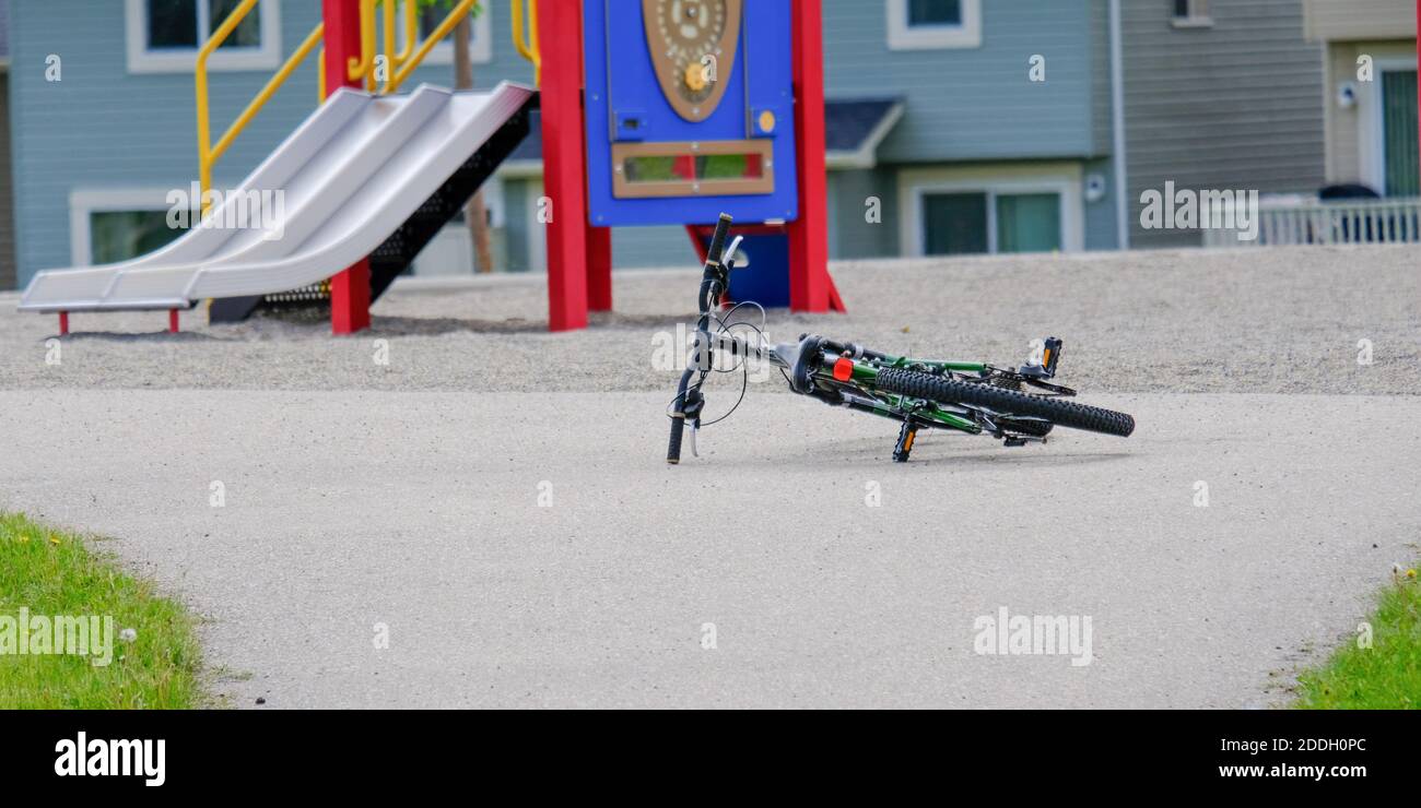 Bicycle on the ground at a childrens playground Stock Photo - Alamy
