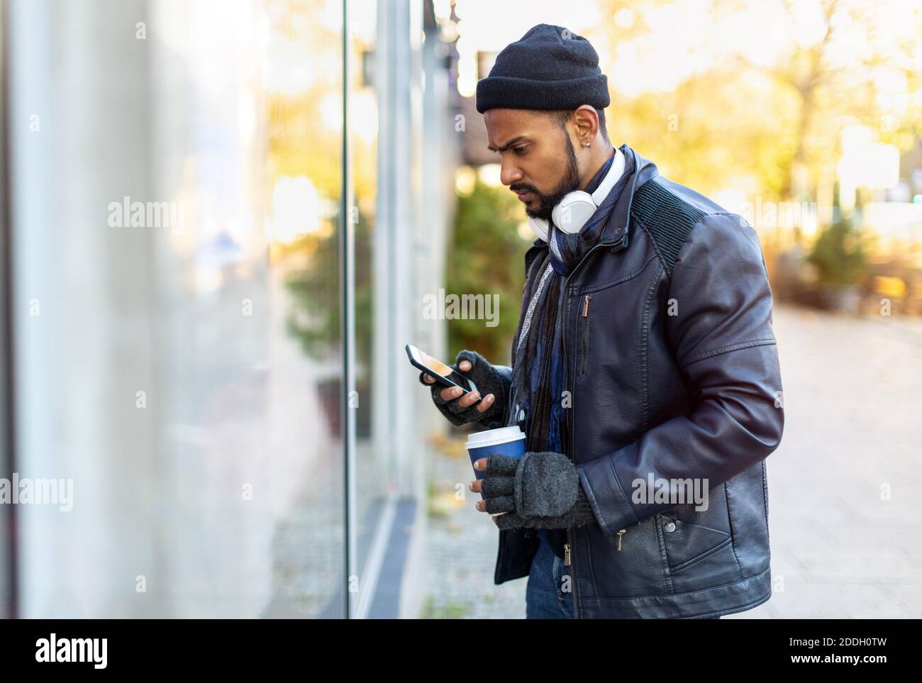 Young man window shopping on city street Stock Photo - Alamy