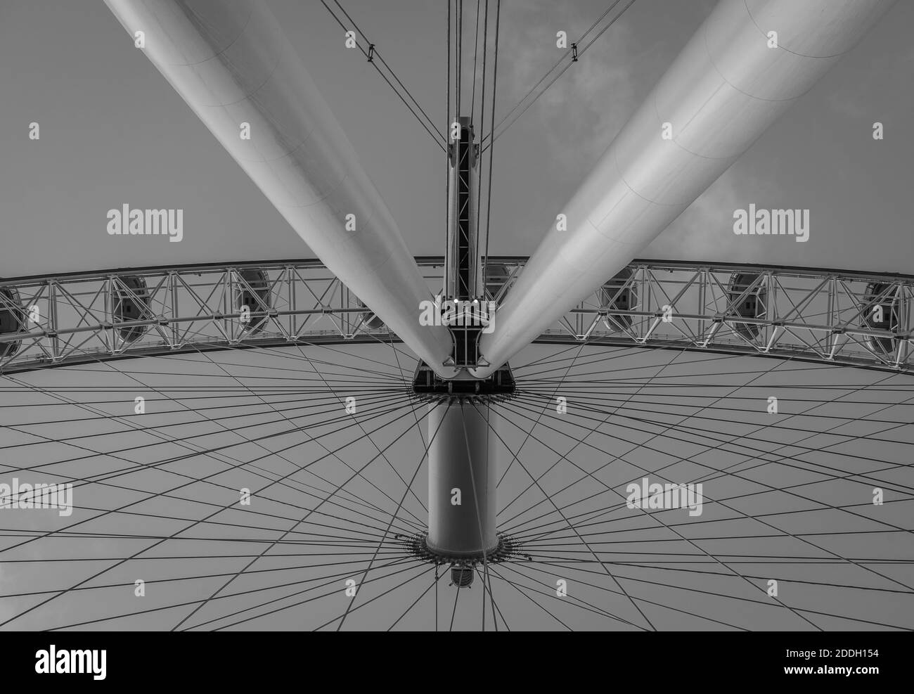 A low angle grayscale shot of rotating Ferris wheel details Stock Photo ...