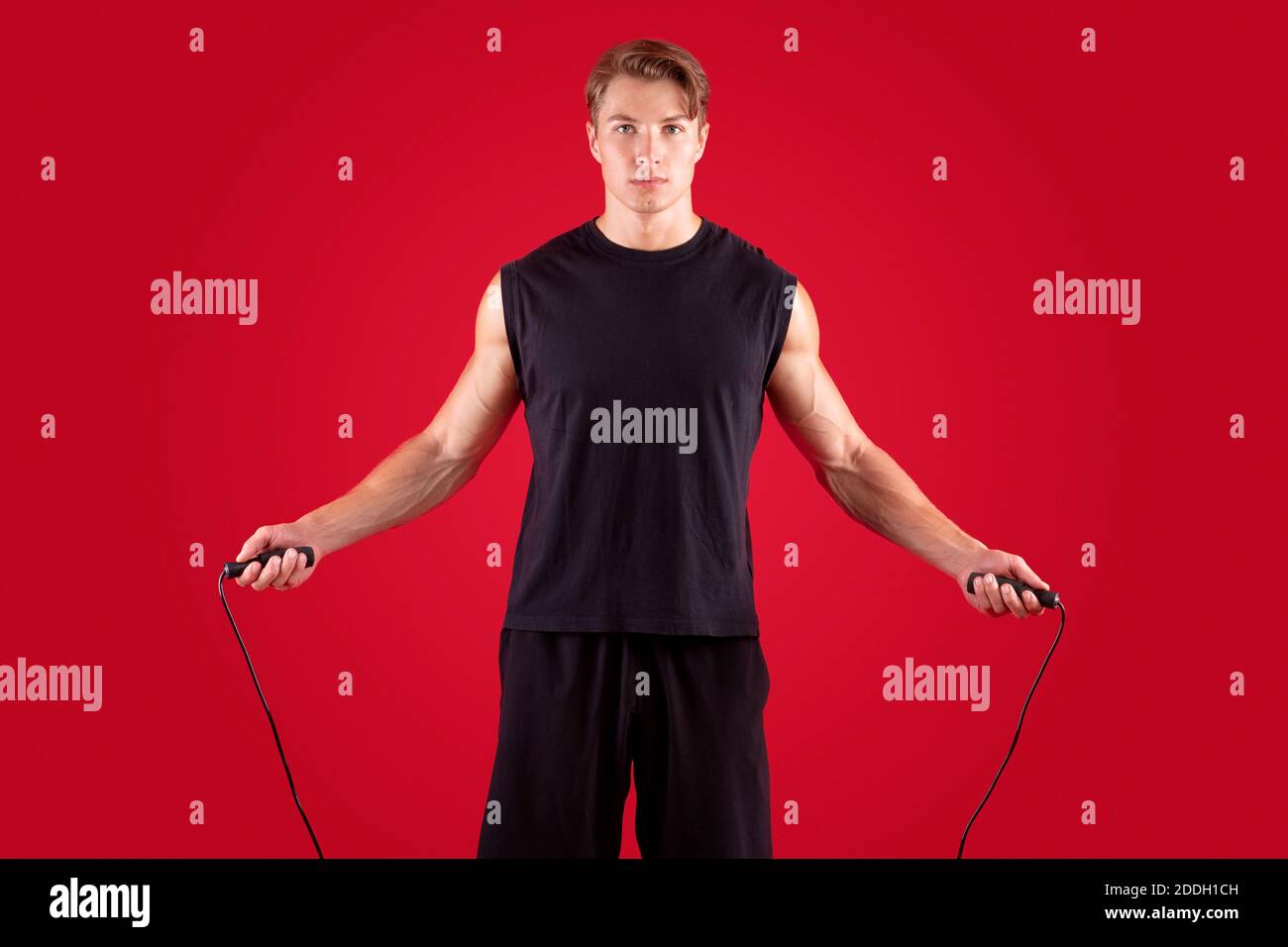 Aerobic workout concept. Serious athletic millennial guy jumping on ...