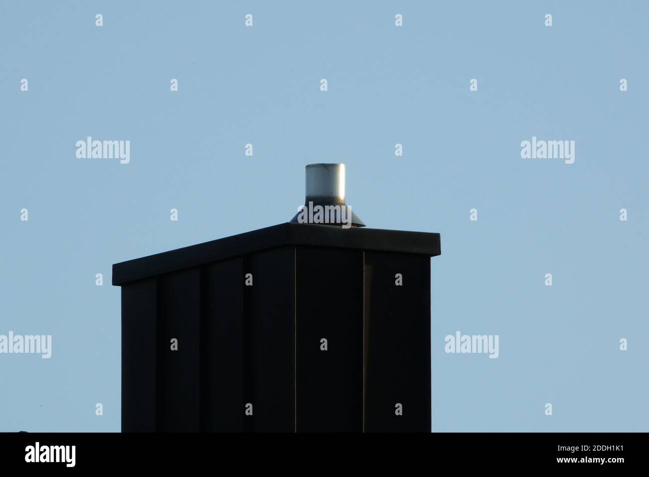 A closeup shot of a modern chimney on a metal building cladding Stock ...