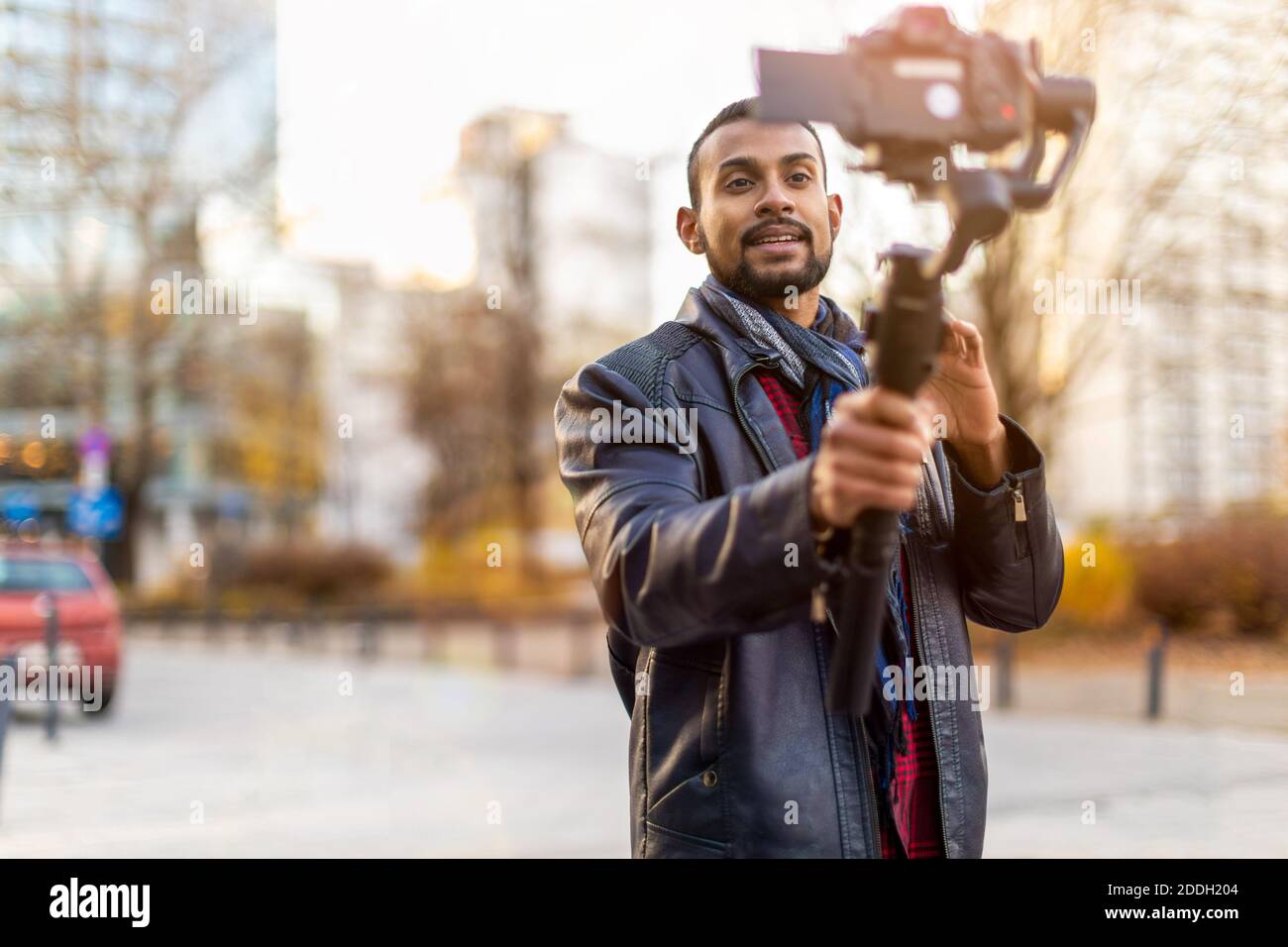 Man filming a vlog with camera in the city Stock Photo - Alamy