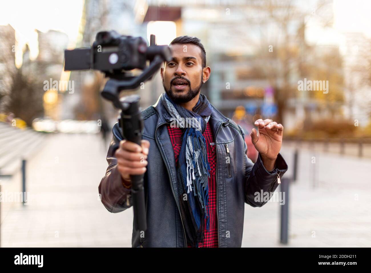 Man filming a vlog with camera in the city Stock Photo - Alamy