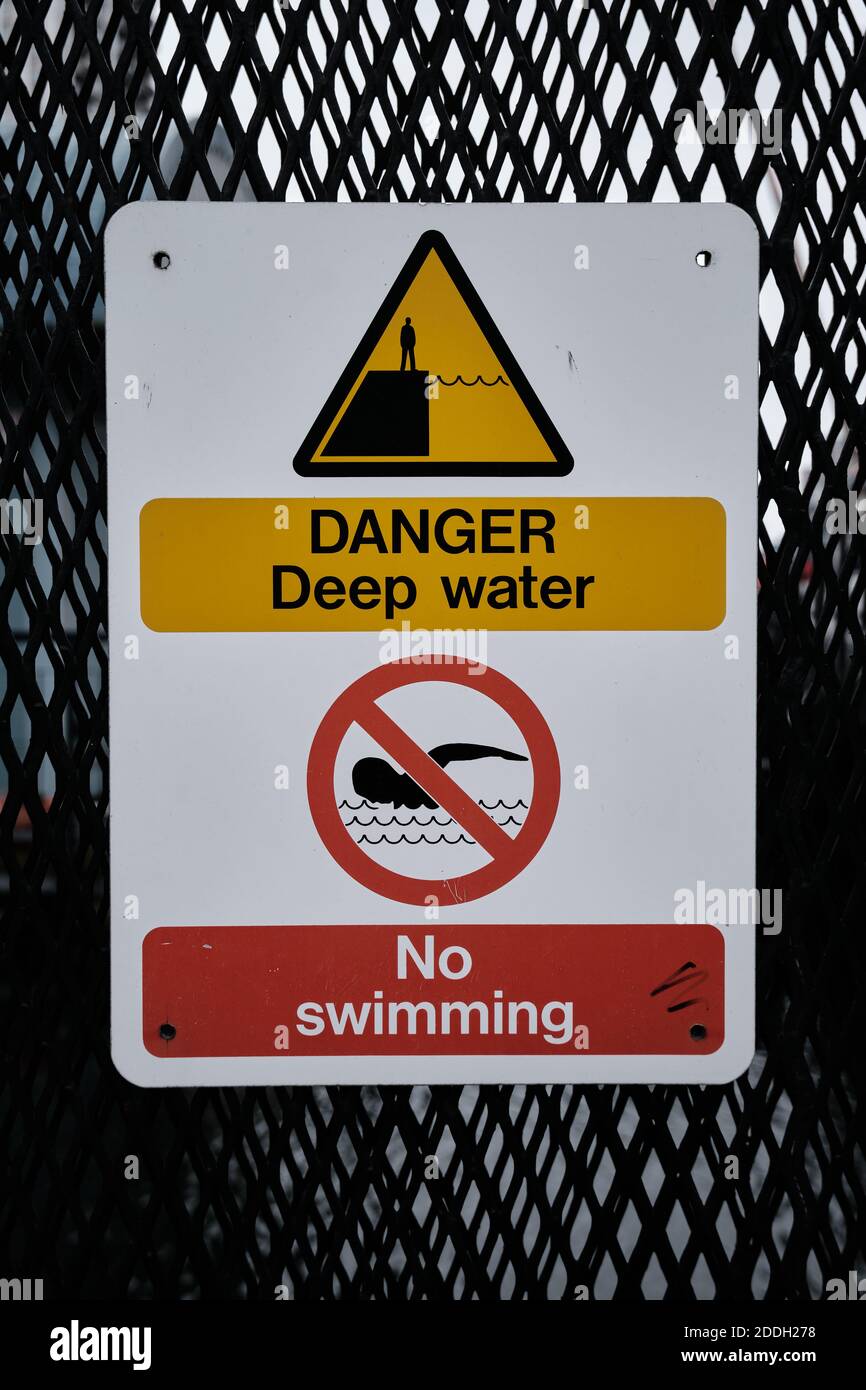 DANGER Deep Water, No Swimming sign on black metal fence Stock Photo ...