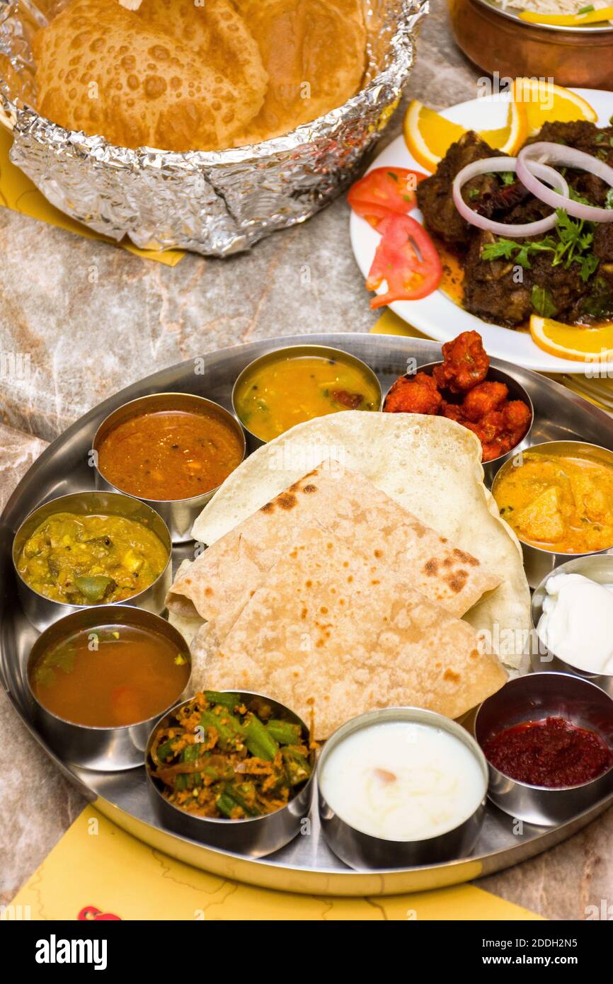 A vertical shot of Indian restaurant non-vegetarian thali with rice ...