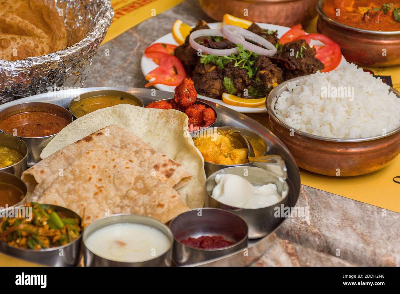 A closeup shot of Indian restaurant non-vegetarian thali with rice ...