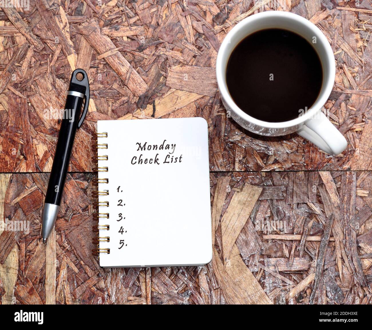 Monday check list written on note pad with background of cup of coffee ...