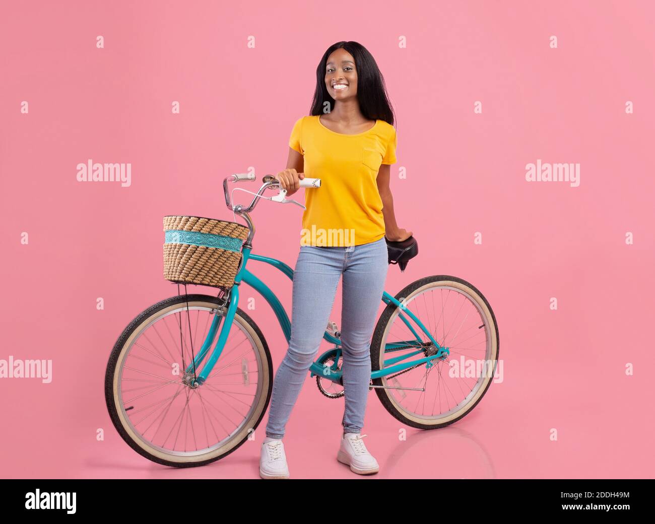 Full length portraif of pretty black lady with vintage bicycle smiling ...