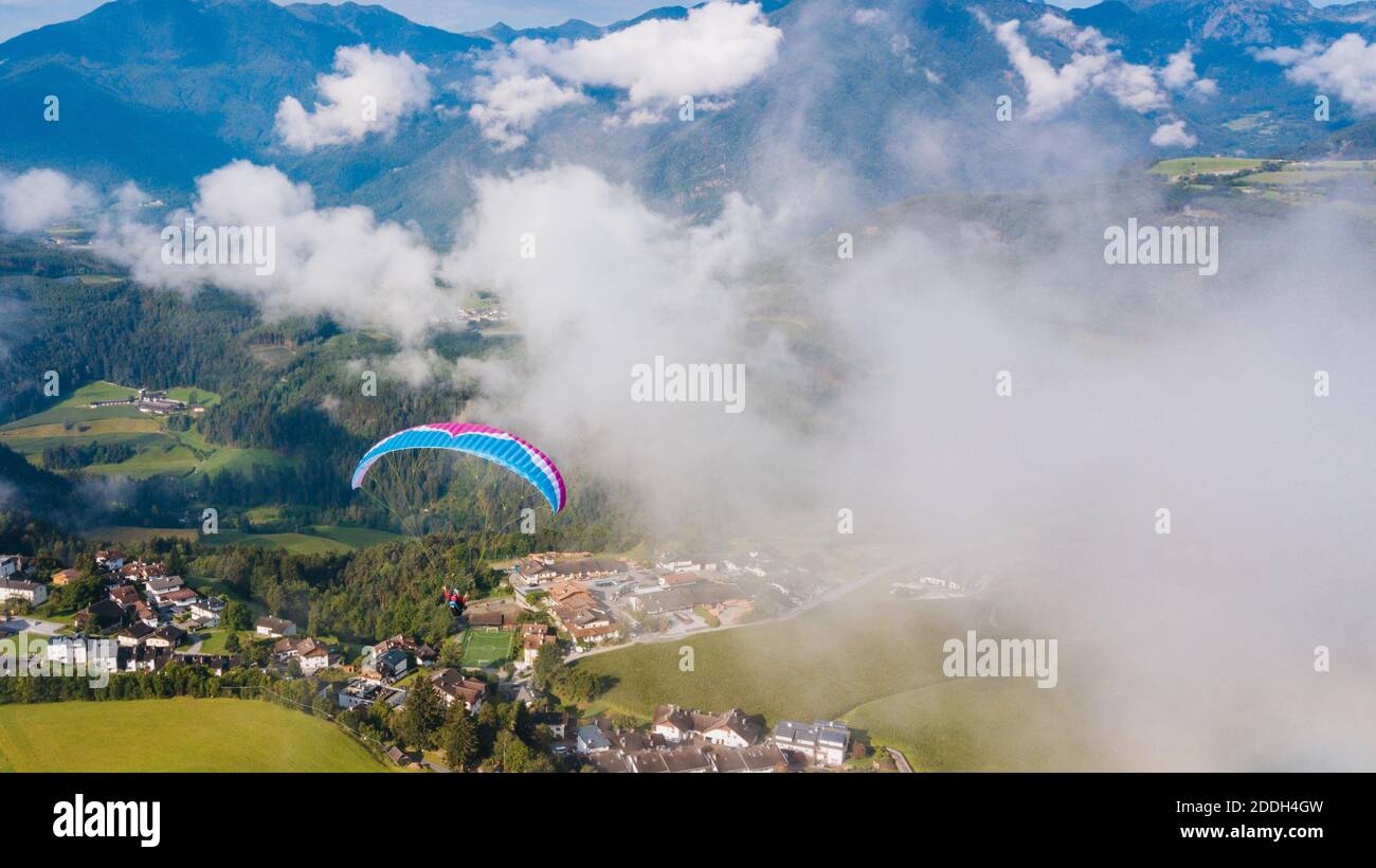 Paragliding through the clouds. Beautiful landscape. Extreme sport ...