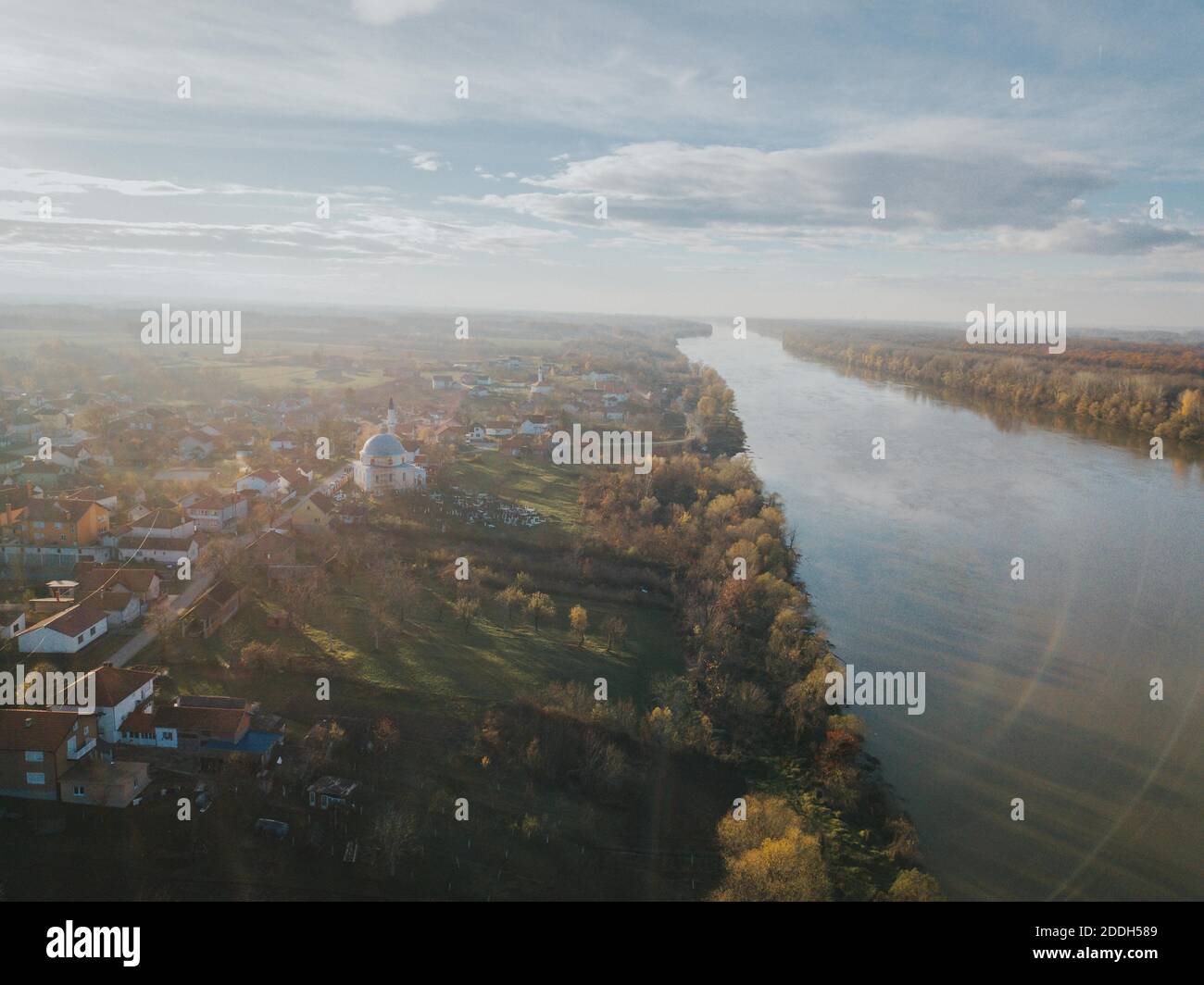 an aerial view of a town along the river under the sunlight Stock Photo ...