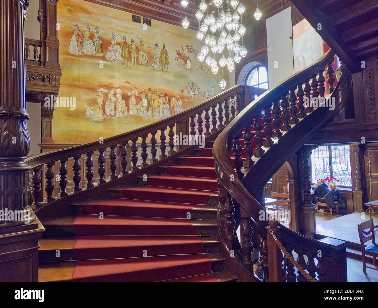 Stairs leading upwards or in a Moszna Castle with a wooden railings and ...