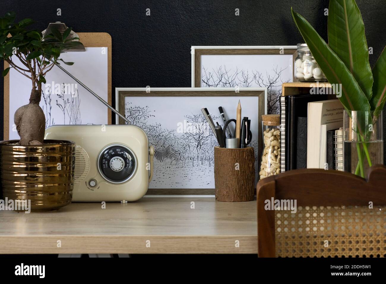 A beautiful but cluttered home office desk with natural decor elements ...