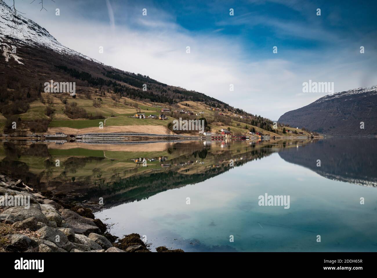 Calm water making reflections of the mountain in Olden, Norway Stock ...