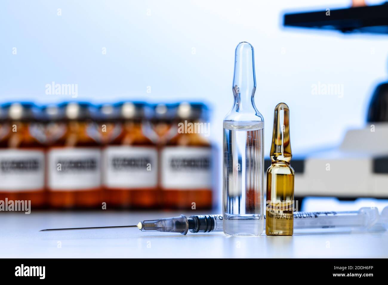 Medical vial with medication near microscope photo Stock Photo - Alamy