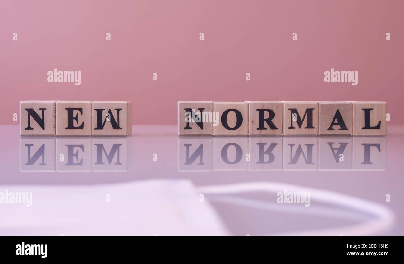 Text NEW NORMAL on wood cube blocks. The letters NEW NORMAL written on ...